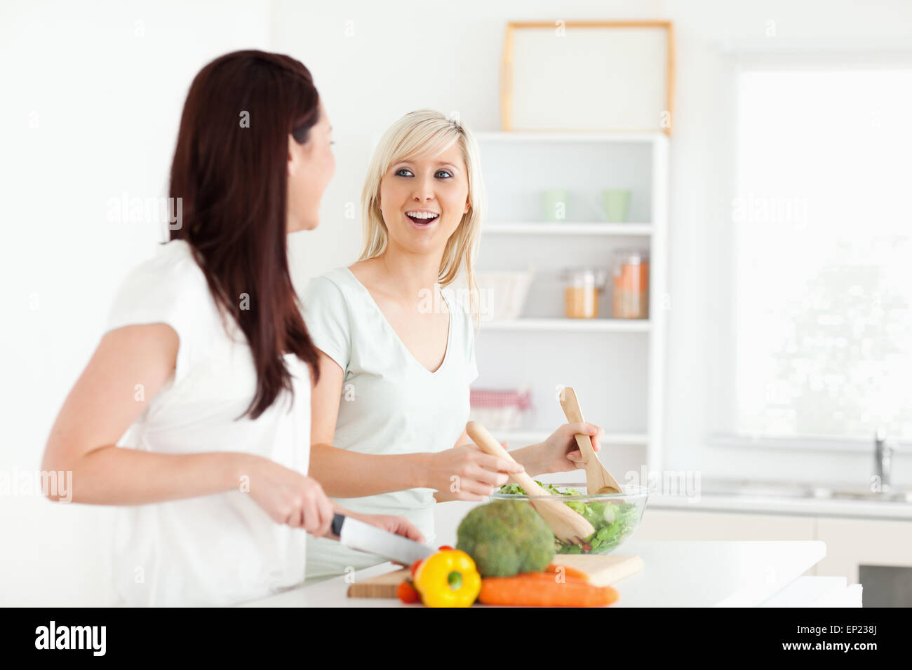 Cheering young Women preparing dinner Stock Photo - Alamy