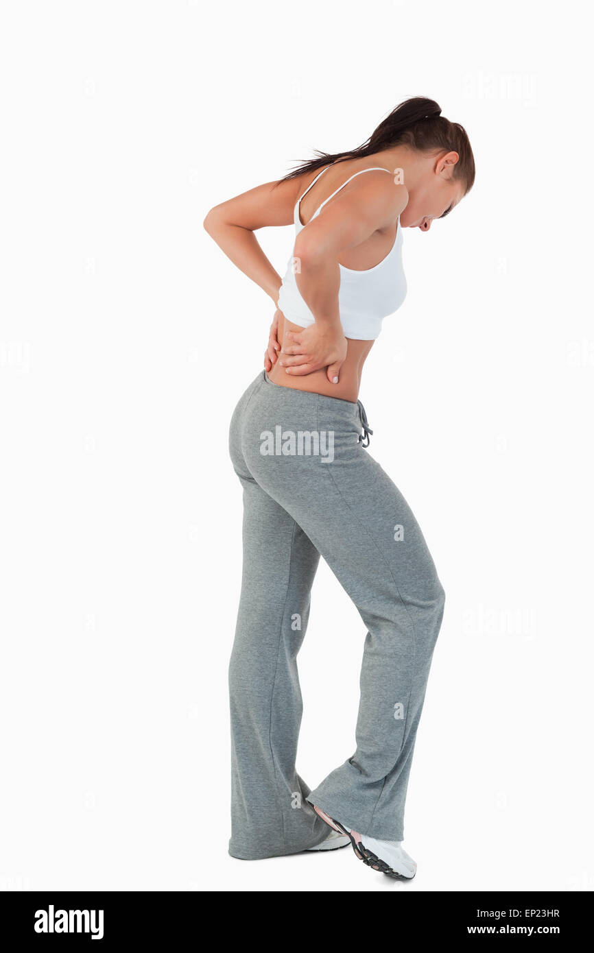 Side view of young woman with hands on her hip Stock Photo - Alamy
