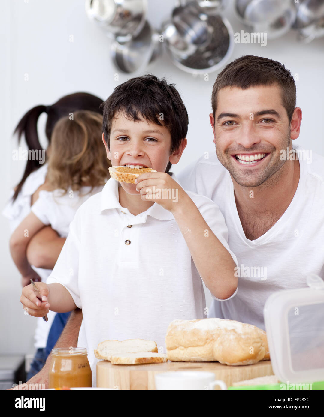 Father and son eating a toast in breakfast time Stock Photo - Alamy