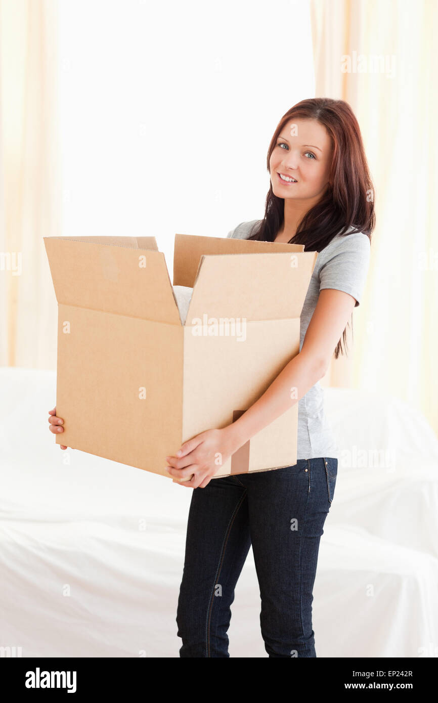 Woman holding filled cardboard Stock Photo - Alamy