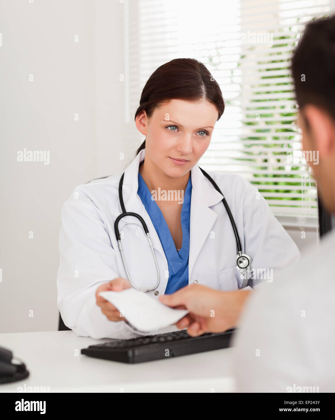 Female doctor presenting prescription to patient Stock Photo - Alamy