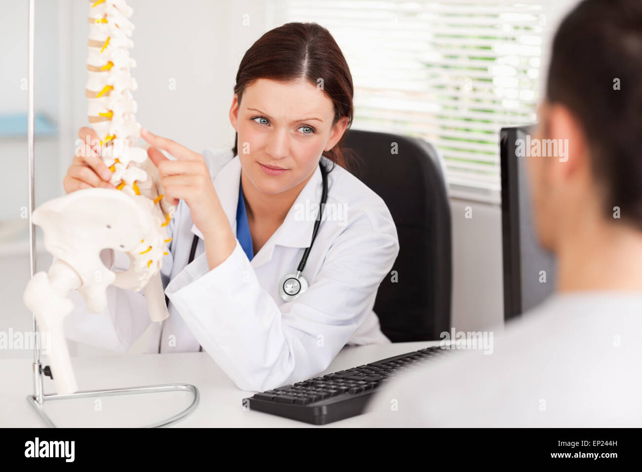 Female doctor showing doctor something Stock Photo - Alamy