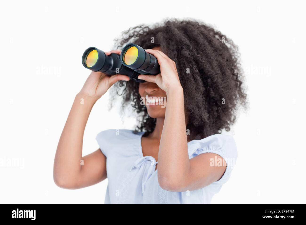 Young woman looking on the side through binoculars Stock Photo - Alamy