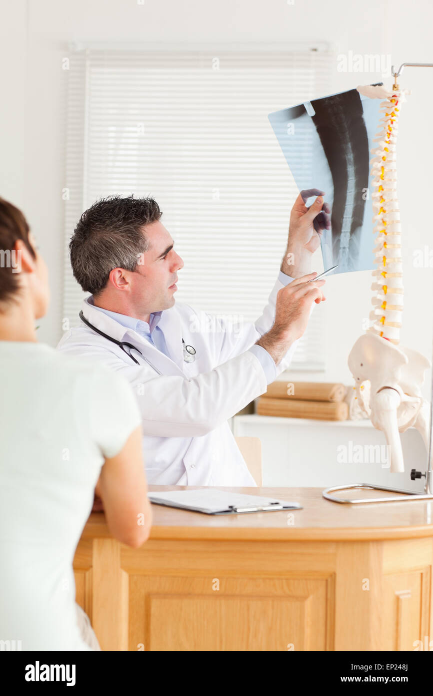 Doctor showing a patient a x-ray Stock Photo - Alamy