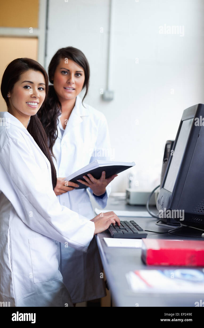 Portrait of female scientist posing with a monitor Stock Photo - Alamy