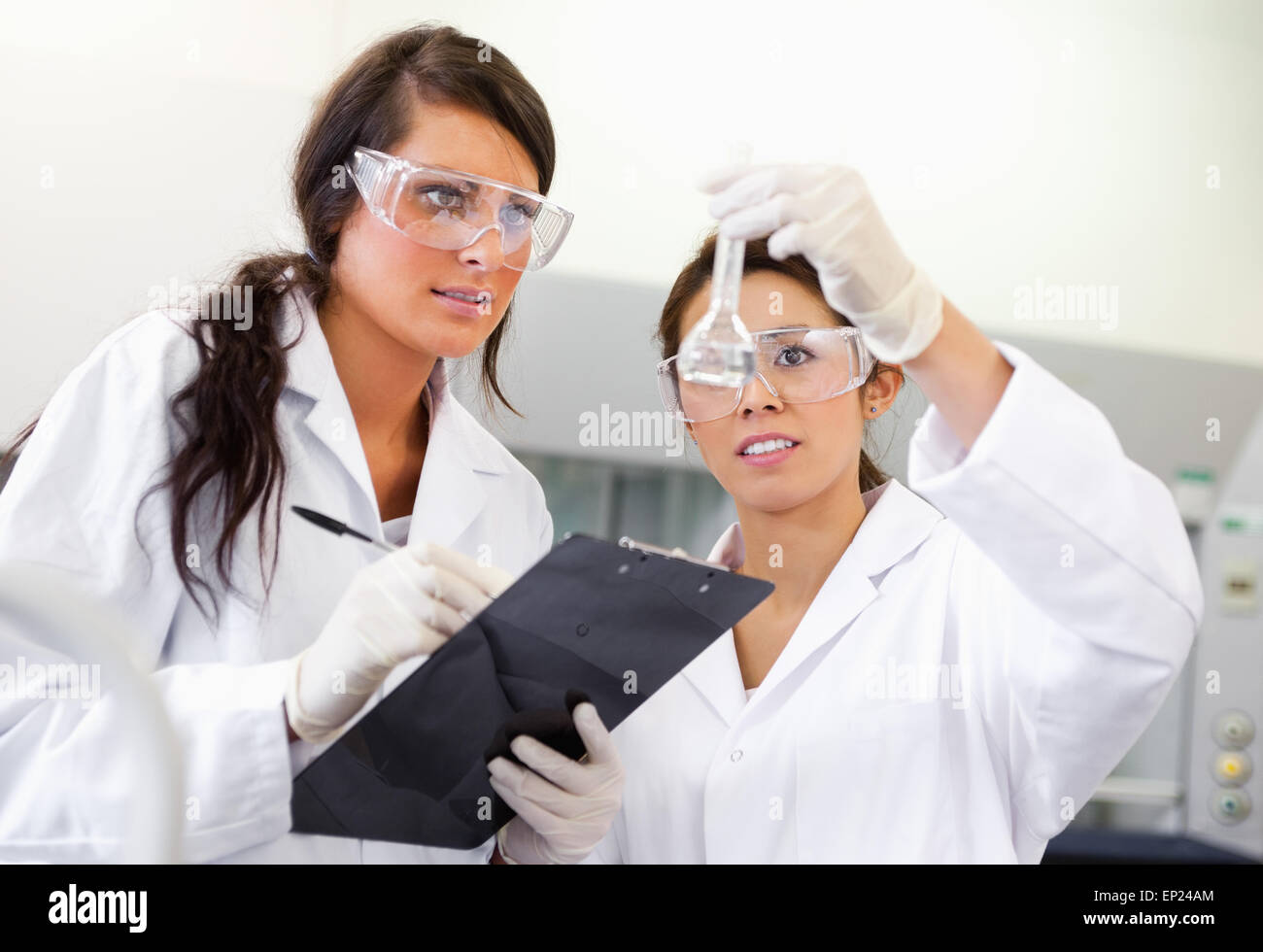 Scientist looking at a Erlenmeyer flask Stock Photo - Alamy