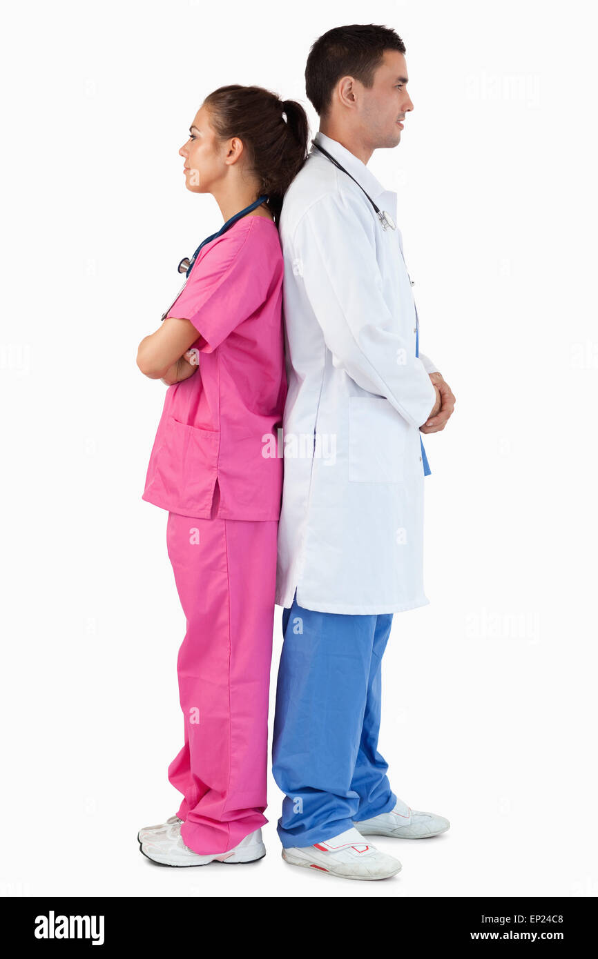 Portrait of a doctor and a nurse posing back to back Stock Photo - Alamy