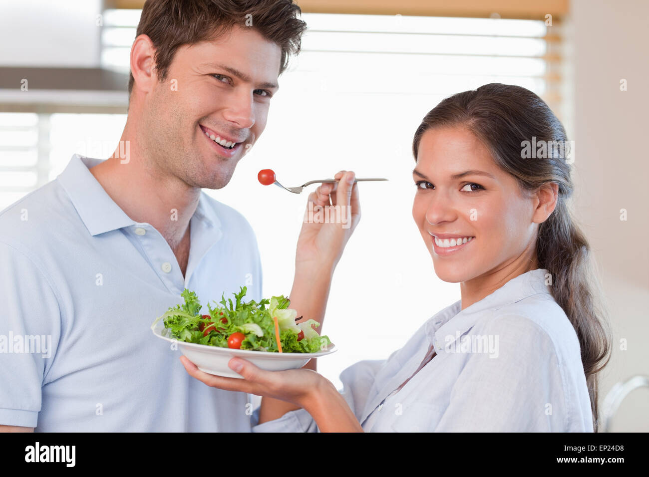Housewife feeding her husband Stock Photo - Alamy
