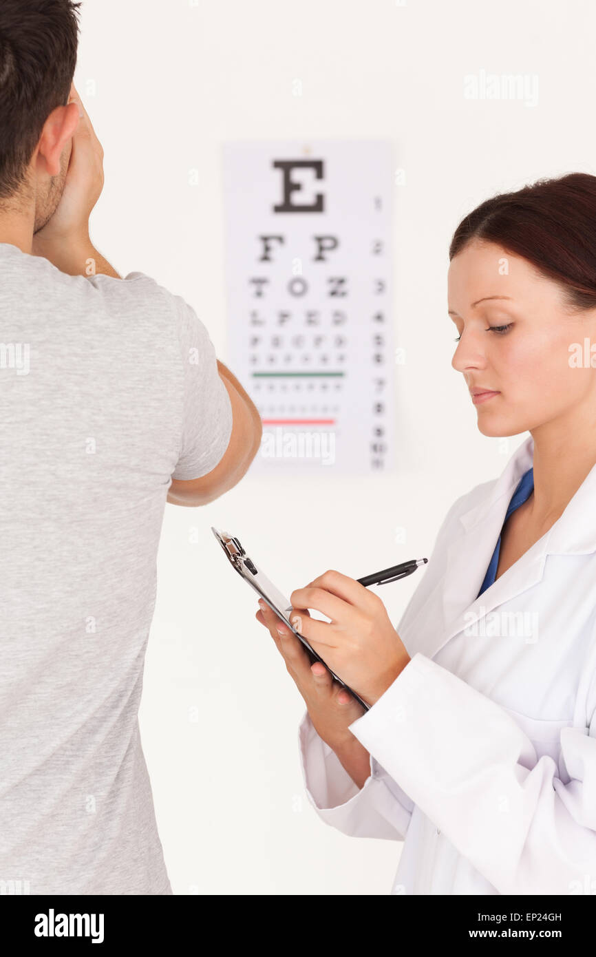 Female optician testing eyes of a man Stock Photo - Alamy
