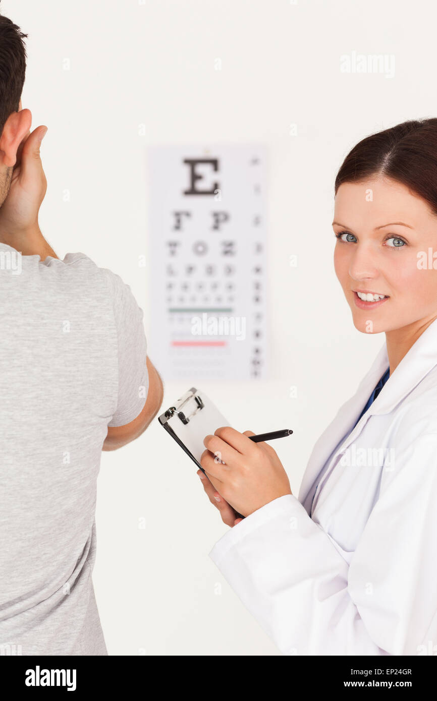 Female optician making notes Stock Photo - Alamy
