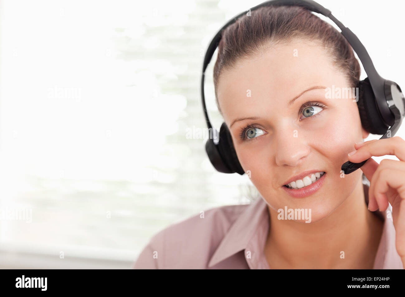 An operator with headset helping someone Stock Photo - Alamy