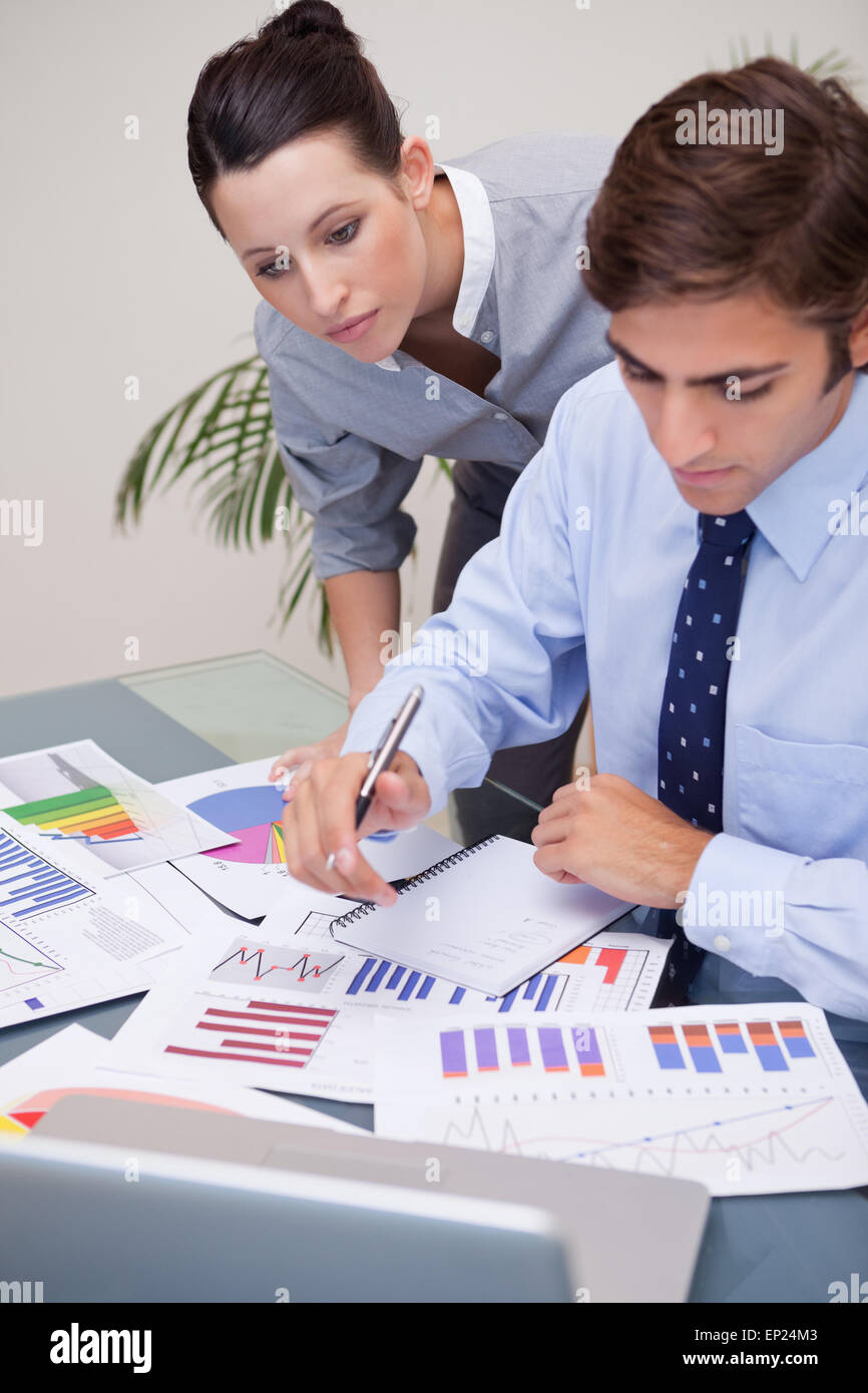 Business team analyzing statistics together Stock Photo - Alamy Business team analyzing statistics together Stock Photo - Alamy