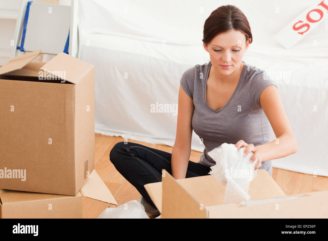 Young woman clearing out Stock Photo - Alamy