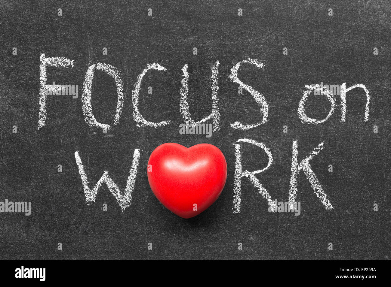 focus on work phrase handwritten on chalkboard with heart symbol ...