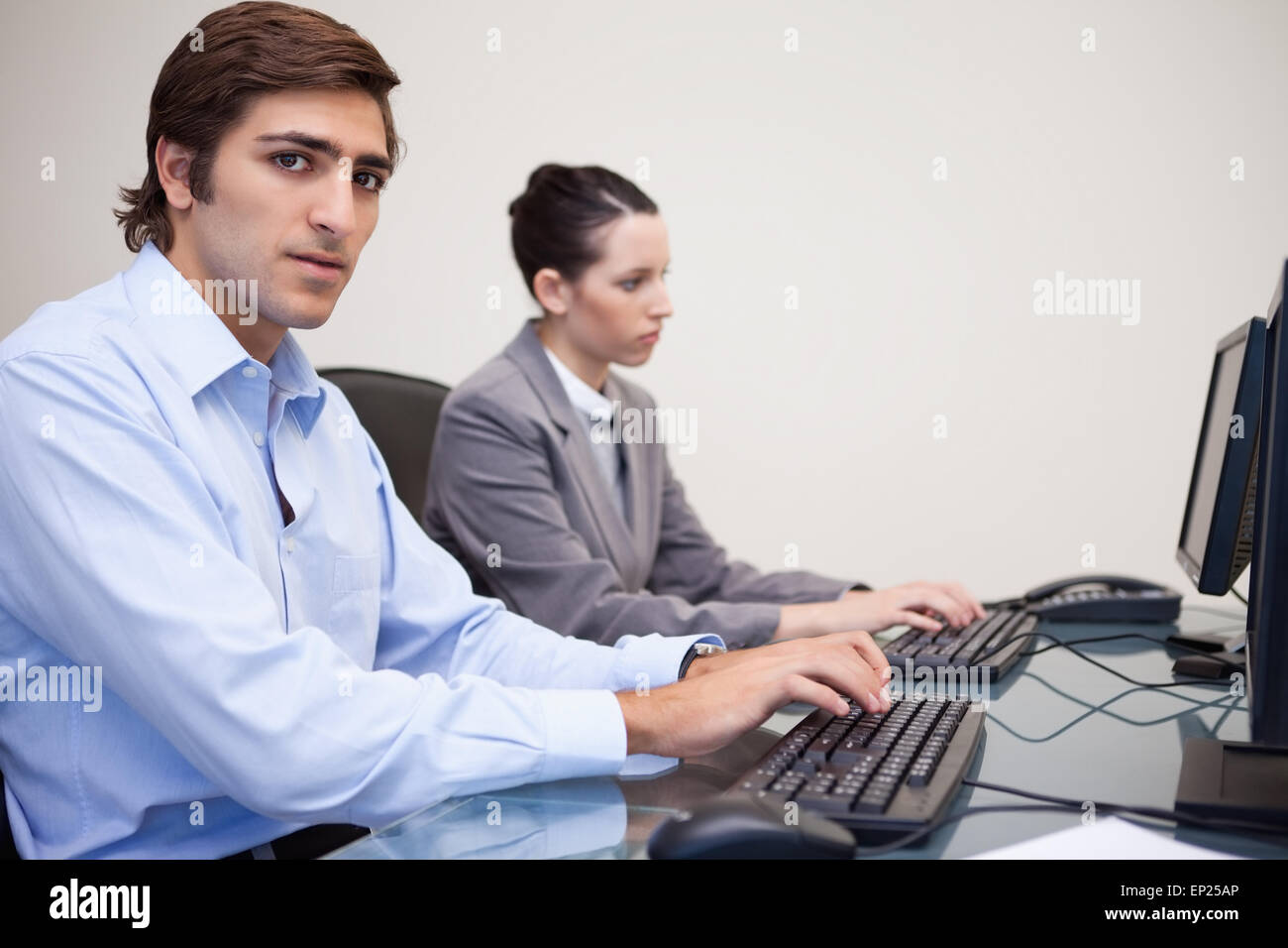 Side view of business people working next to each other Stock Photo - Alamy