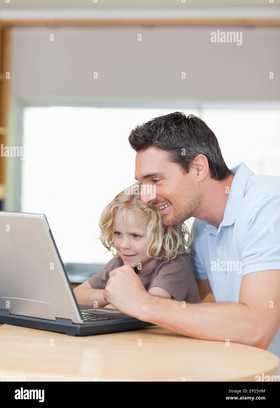 Father and son using laptop together Stock Photo - Alamy
