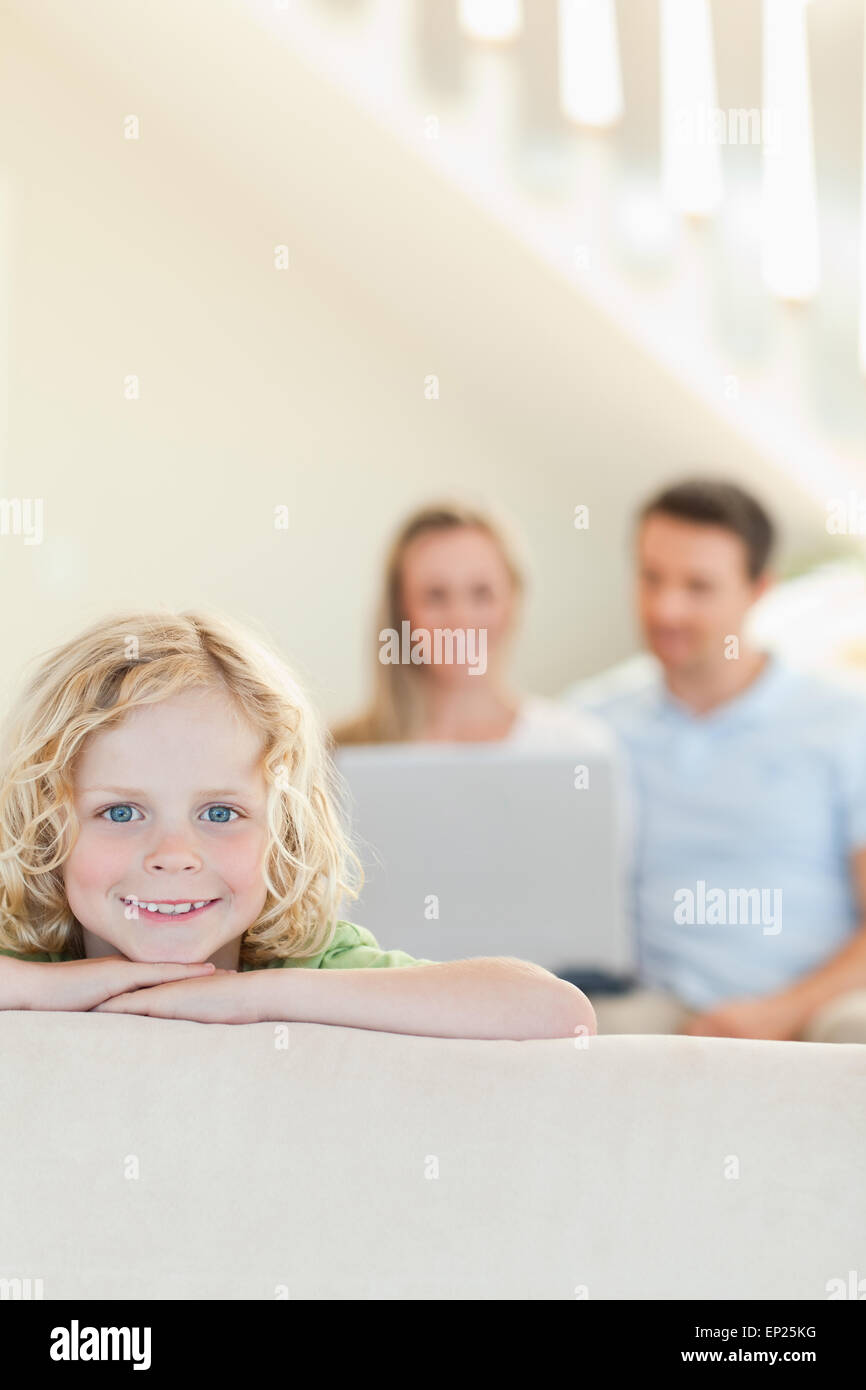Happy boy with parents in the background Stock Photo - Alamy