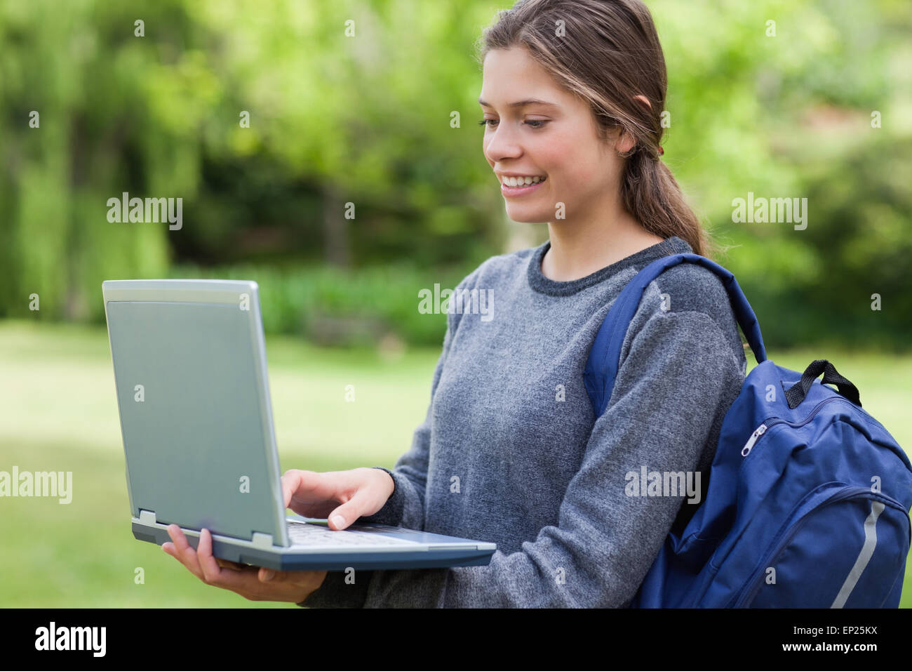 University student carrying laptop smiling hi-res stock photography and ...
