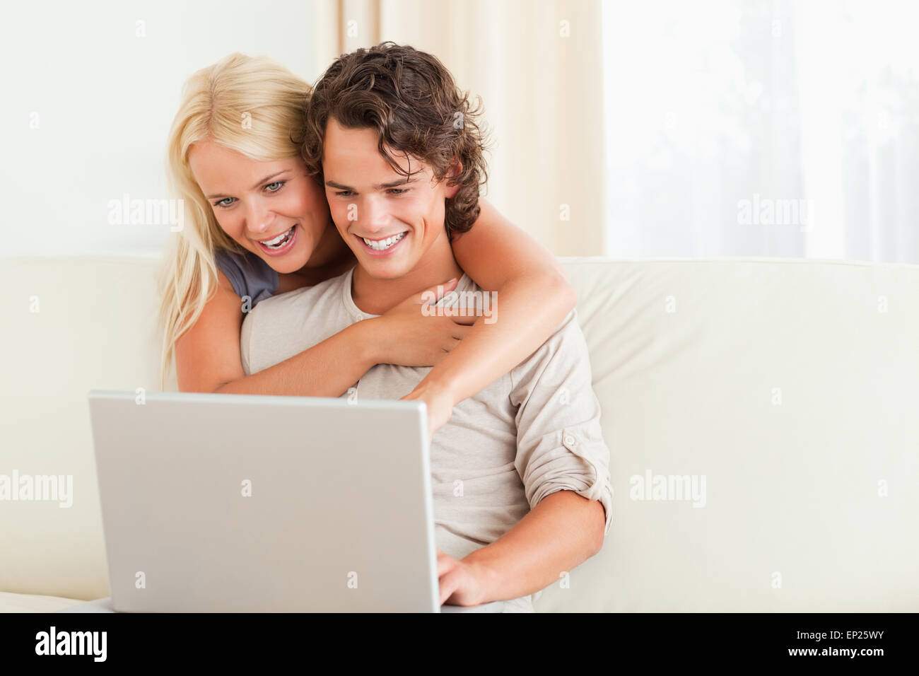 Lovely couple using a notebook Stock Photo - Alamy