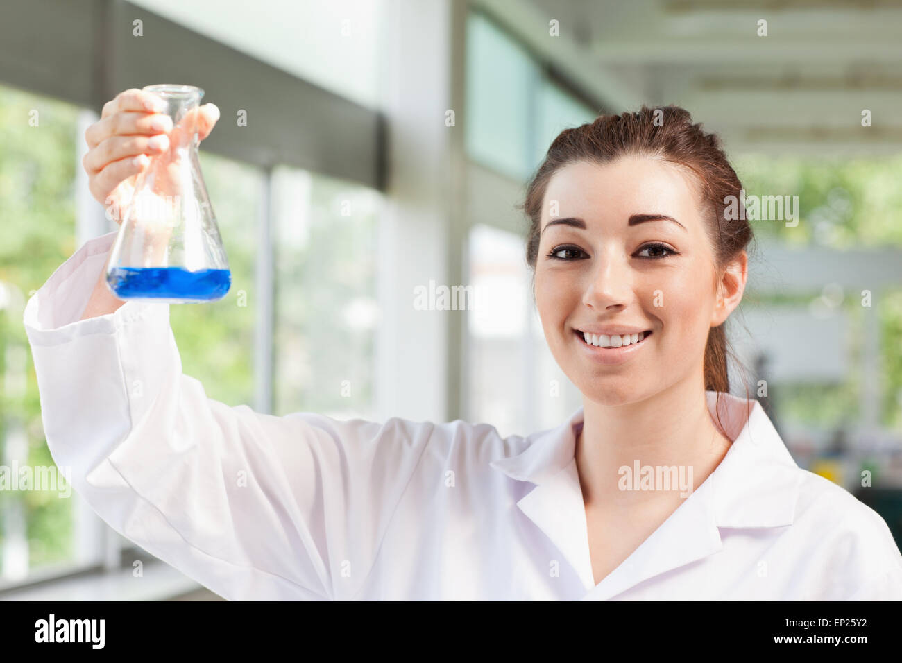 Cute science student holding an Erlemeyer flask Stock Photo - Alamy