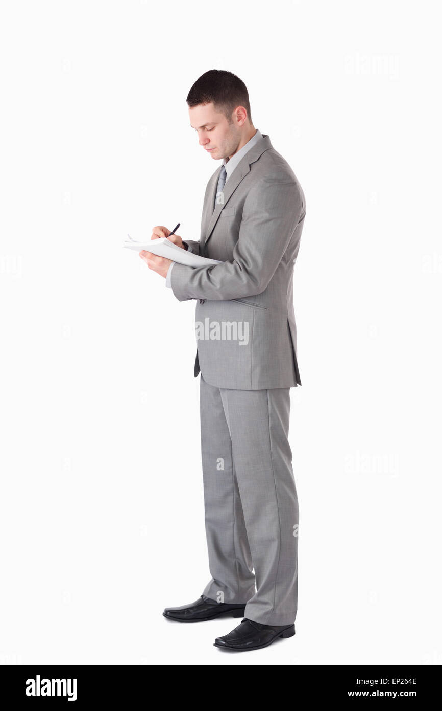 Portrait of a serious businessman taking notes Stock Photo - Alamy