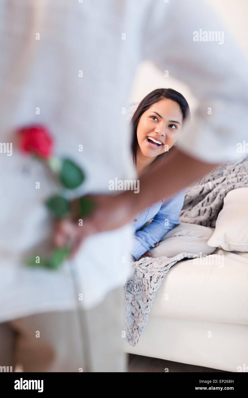 Woman about to get a flower by her boyfriend Stock Photo - Alamy