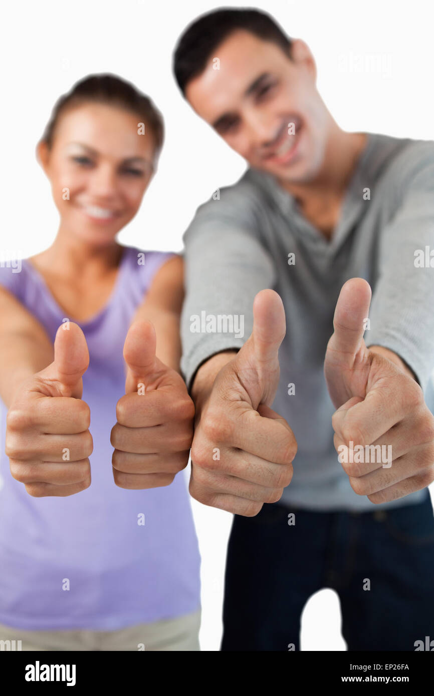 Close up of thumbs up being given by young couple Stock Photo - Alamy