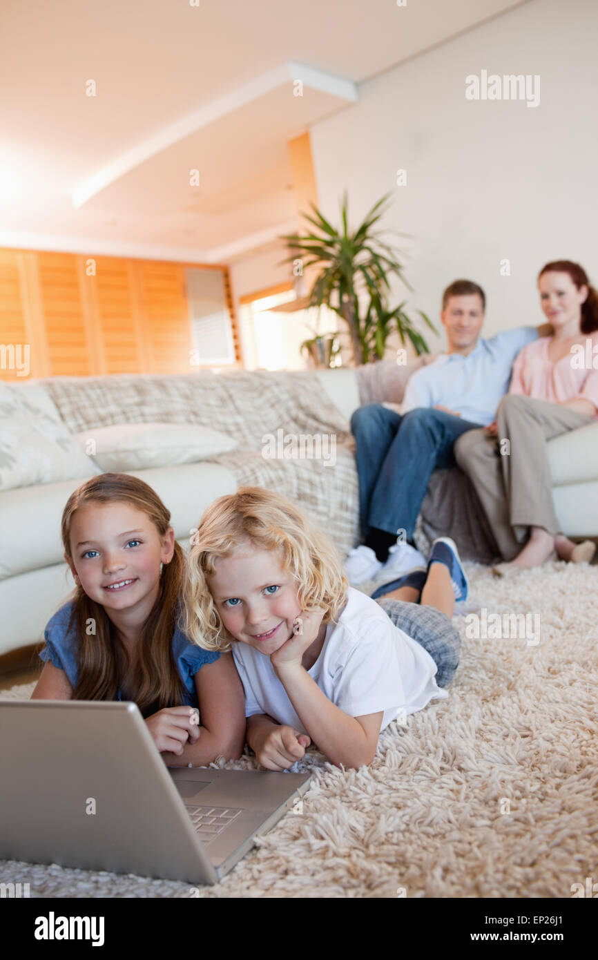 Children on the floor using laptop Stock Photo - Alamy
