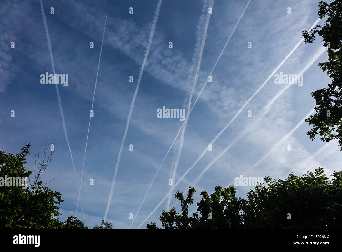 Multiple jet contrails in a vivid blue sky Stock Photo - Alamy