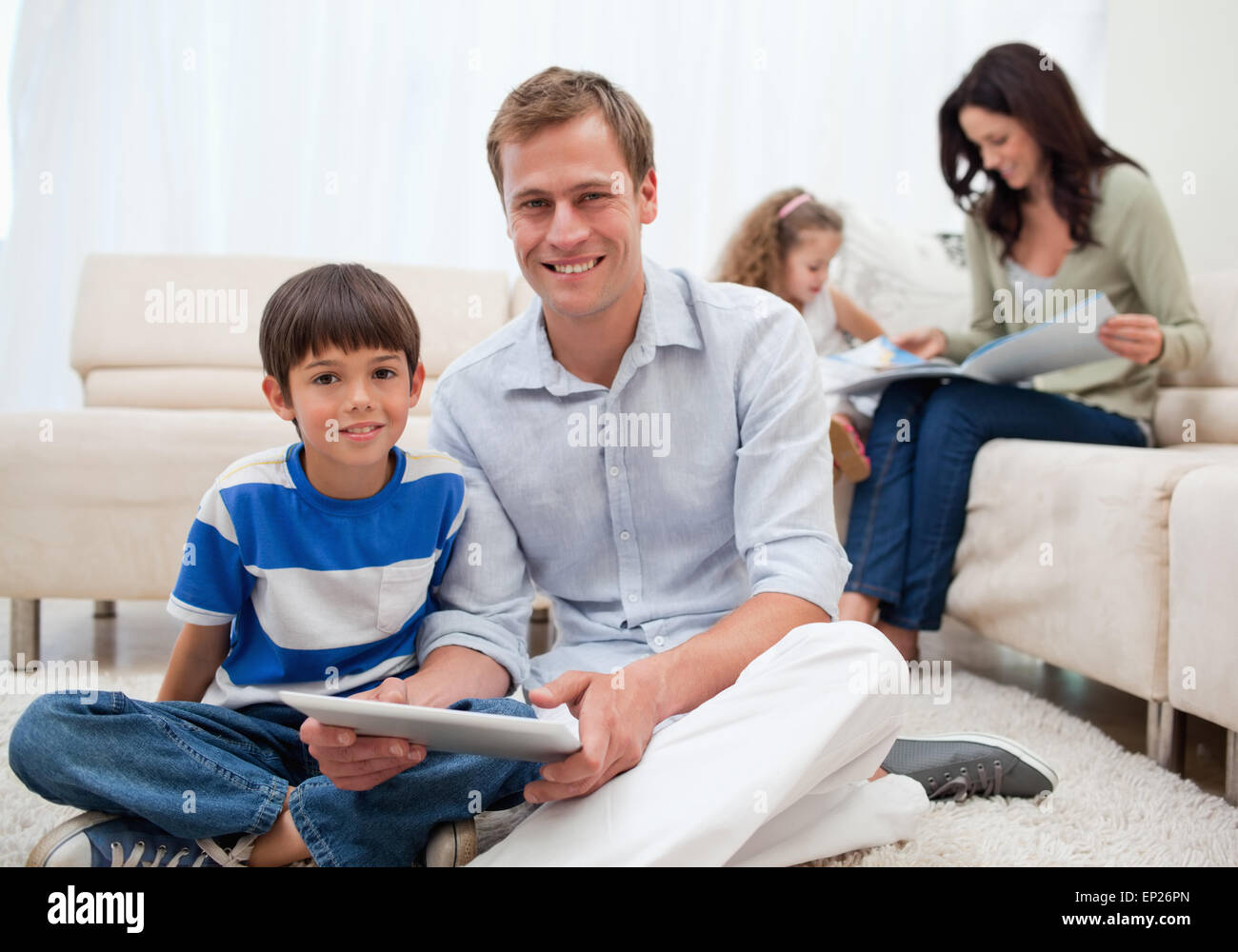 Family spending free time in the living room Stock Photo - Alamy
