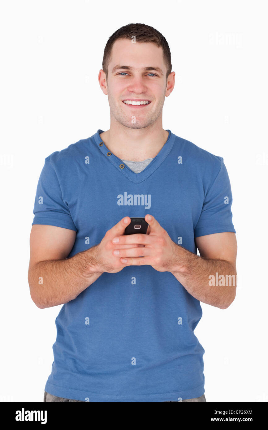 Portrait of a smiling man holding his mobile phone Stock Photo - Alamy