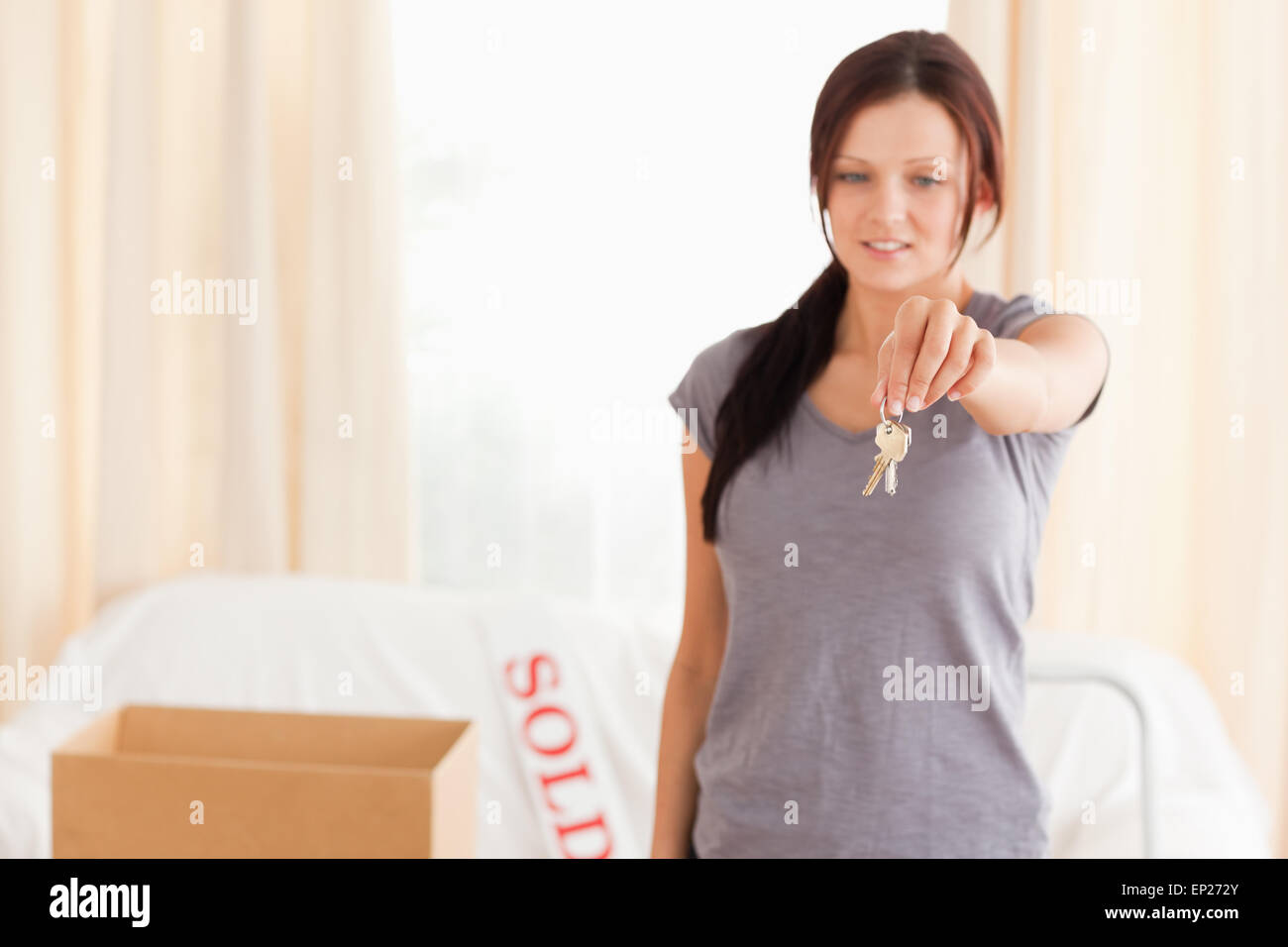 Cute woman holding keys Stock Photo - Alamy
