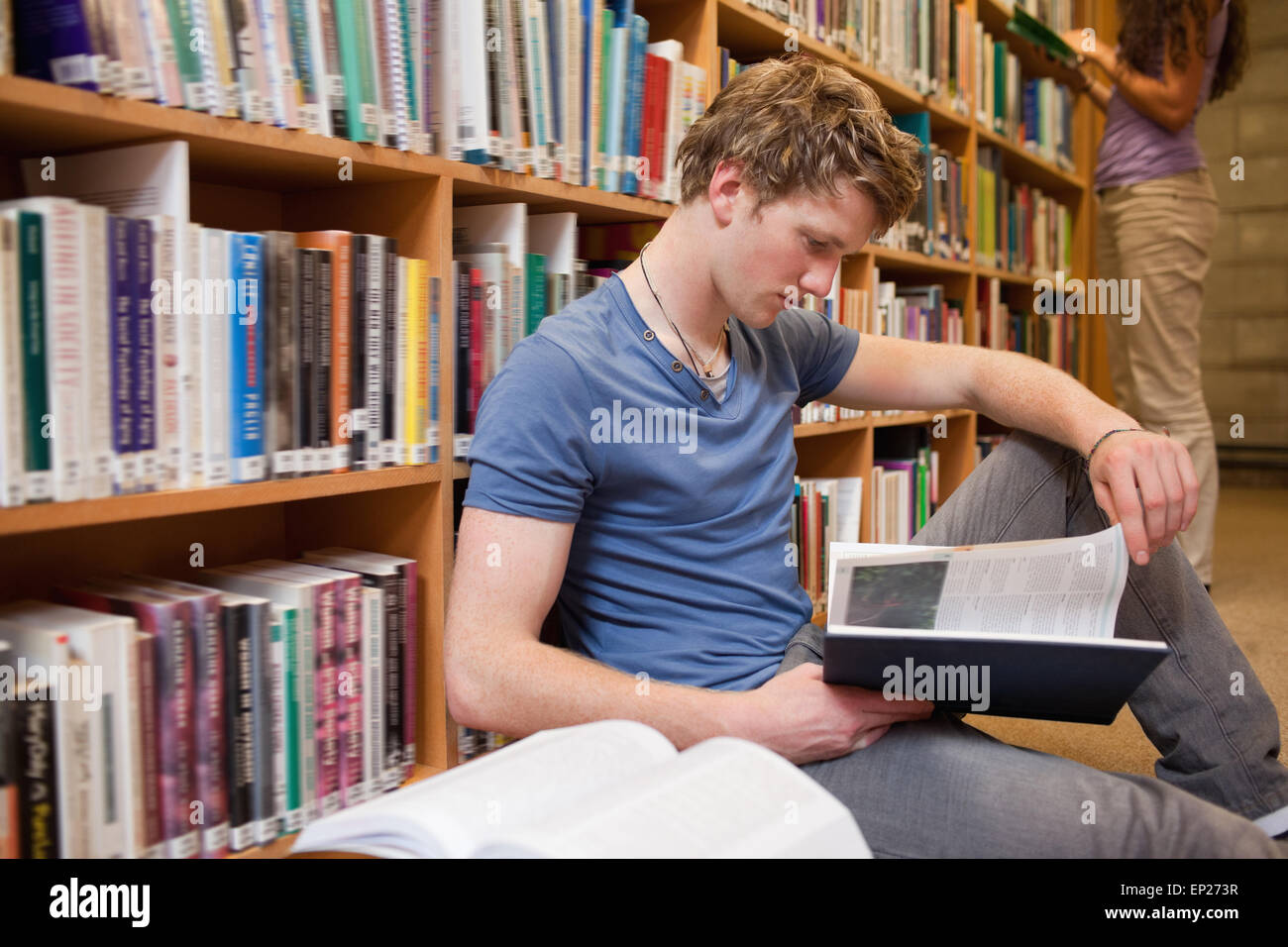Male student reading a book Stock Photo - Alamy