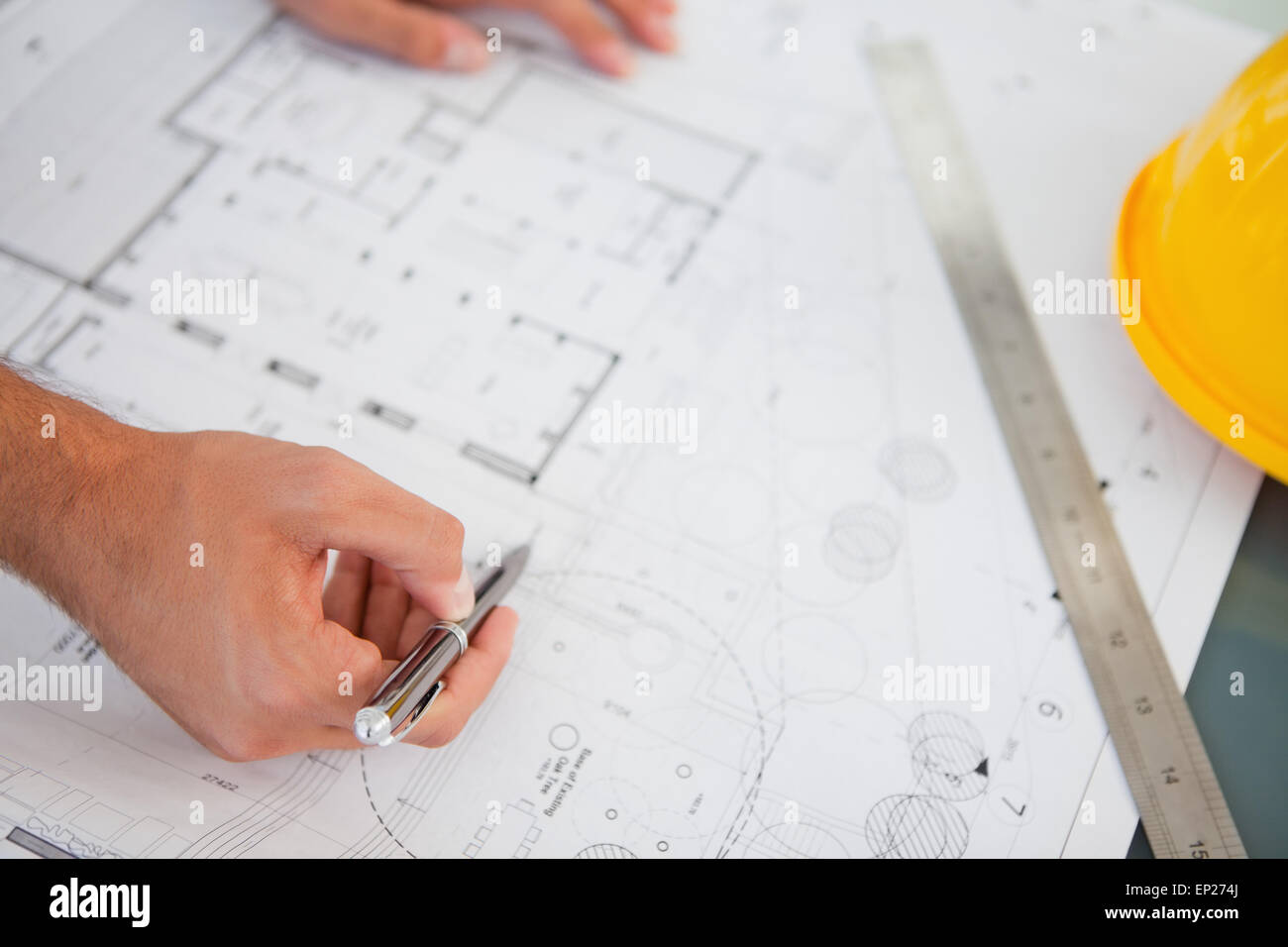 Close up of blueprints with a person making adjustments Stock Photo - Alamy