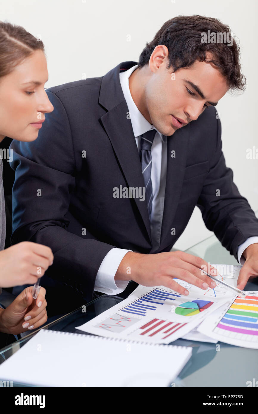 Portrait of a business team studying statistics Stock Photo - Alamy