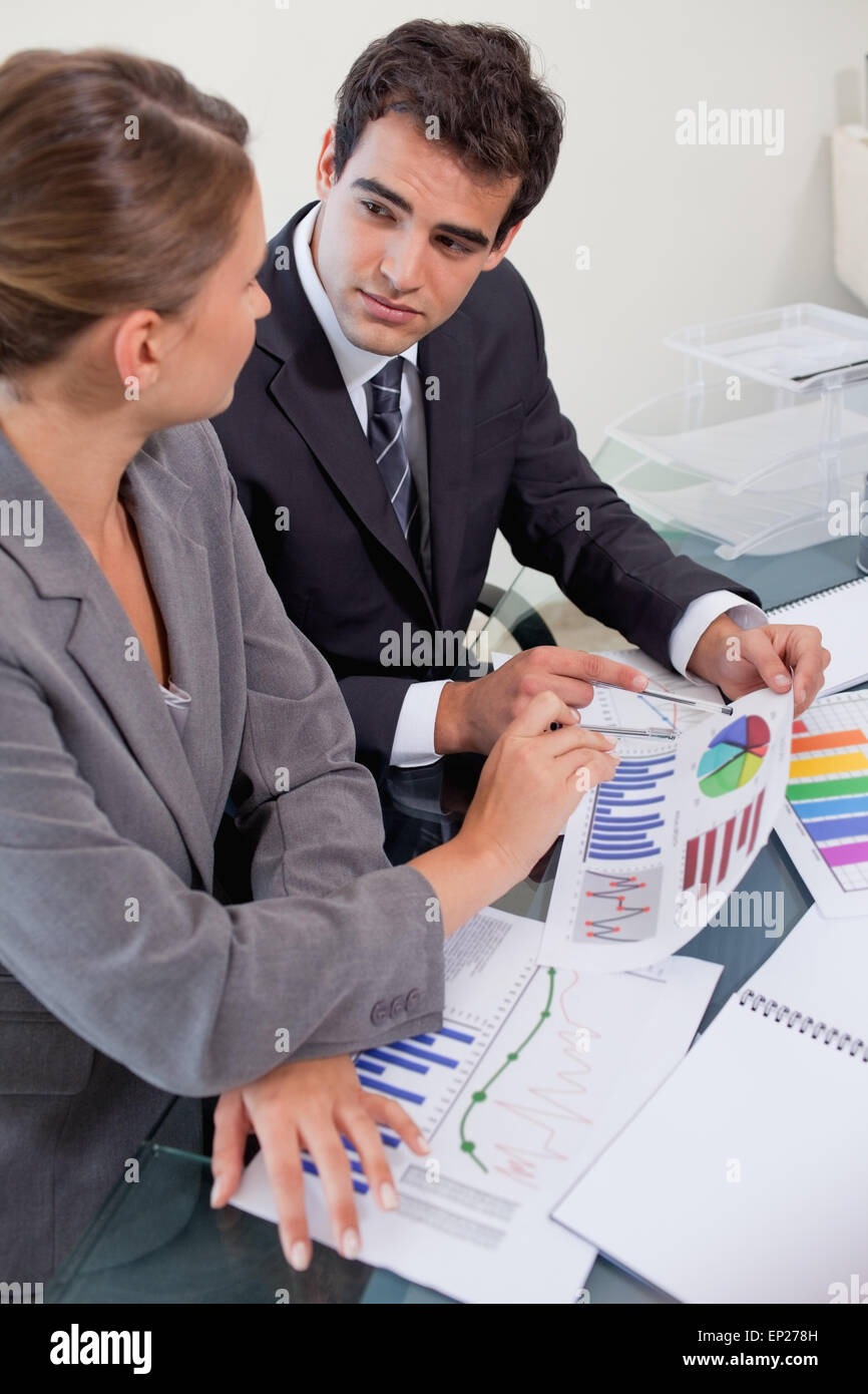 Portrait of a business team studying statistics in a meeting room Stock ...
