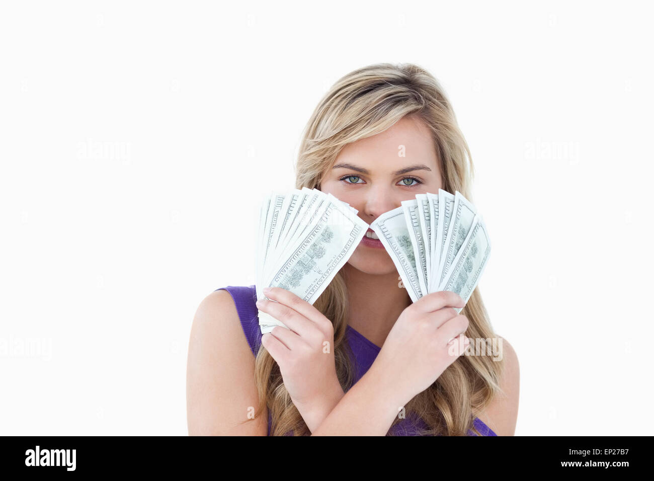 Young blonde woman holding two fans of notes Stock Photo - Alamy