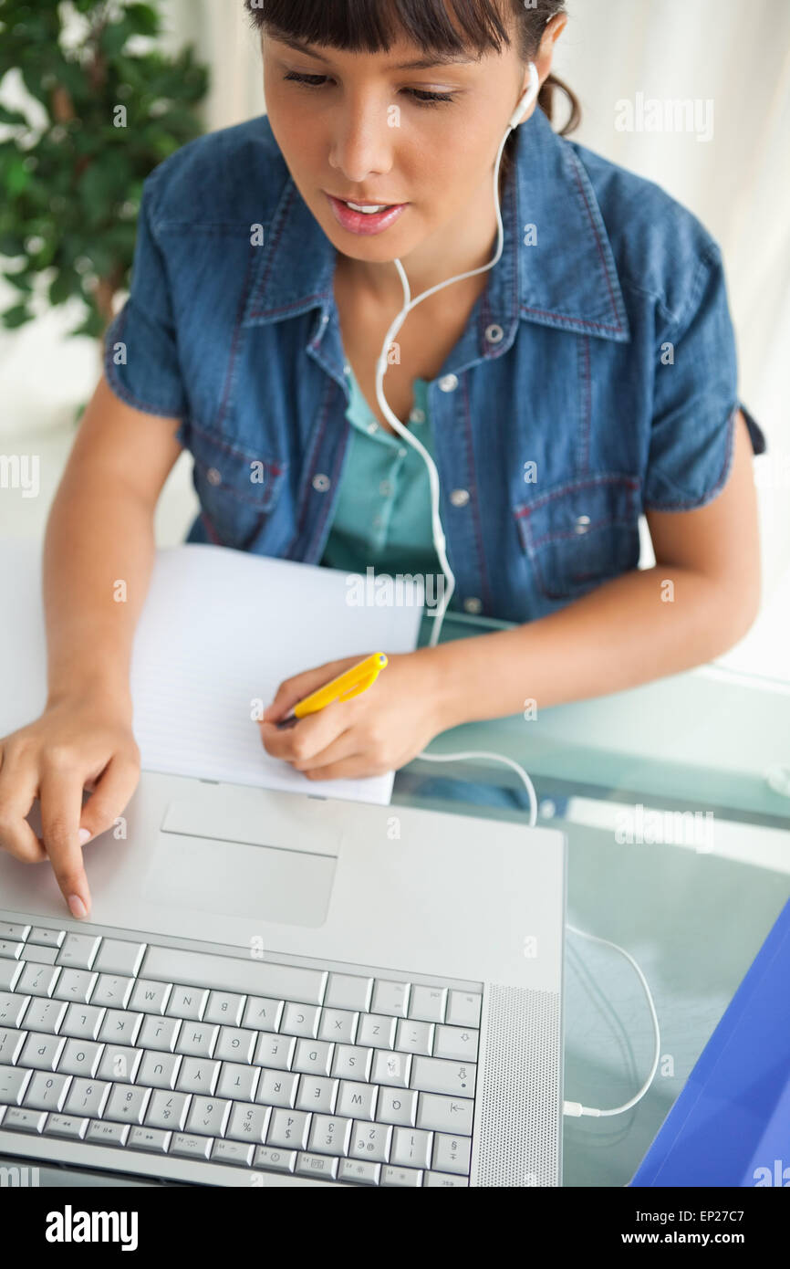 Female student doing his homework while helping with a netbook Stock ...