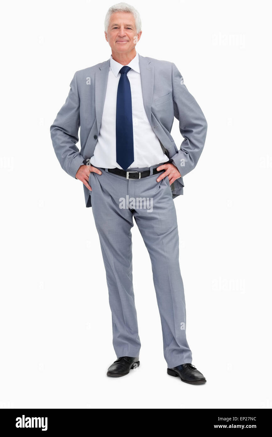 Portrait of a man in a suit with hands on hips Stock Photo - Alamy