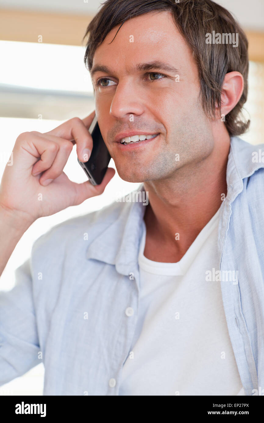 Portrait of a good looking man making a phone call Stock Photo - Alamy