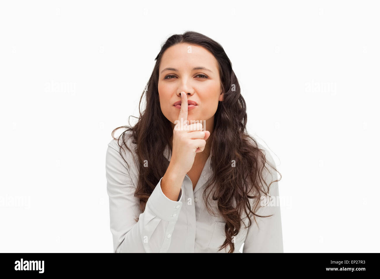 Portrait of a brunette with a finger on the lips Stock Photo - Alamy