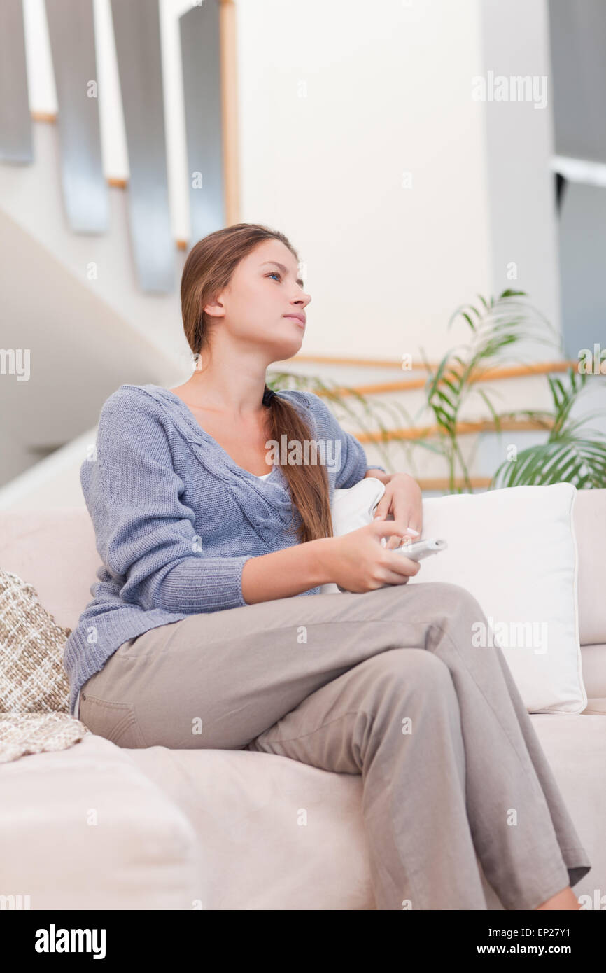 Portrait of a woman watching TV Stock Photo - Alamy