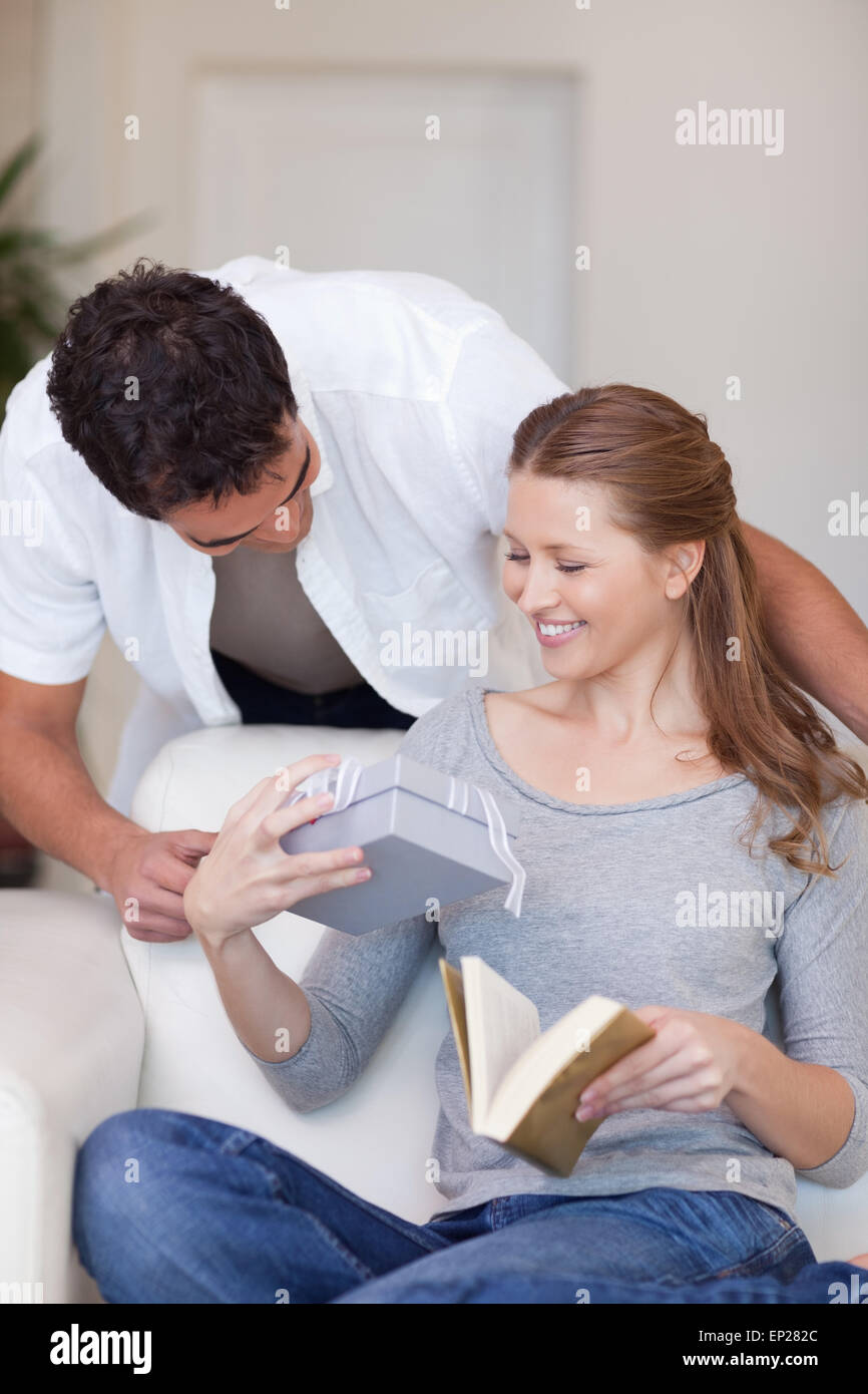 Man handing over present to his girlfriend Stock Photo - Alamy