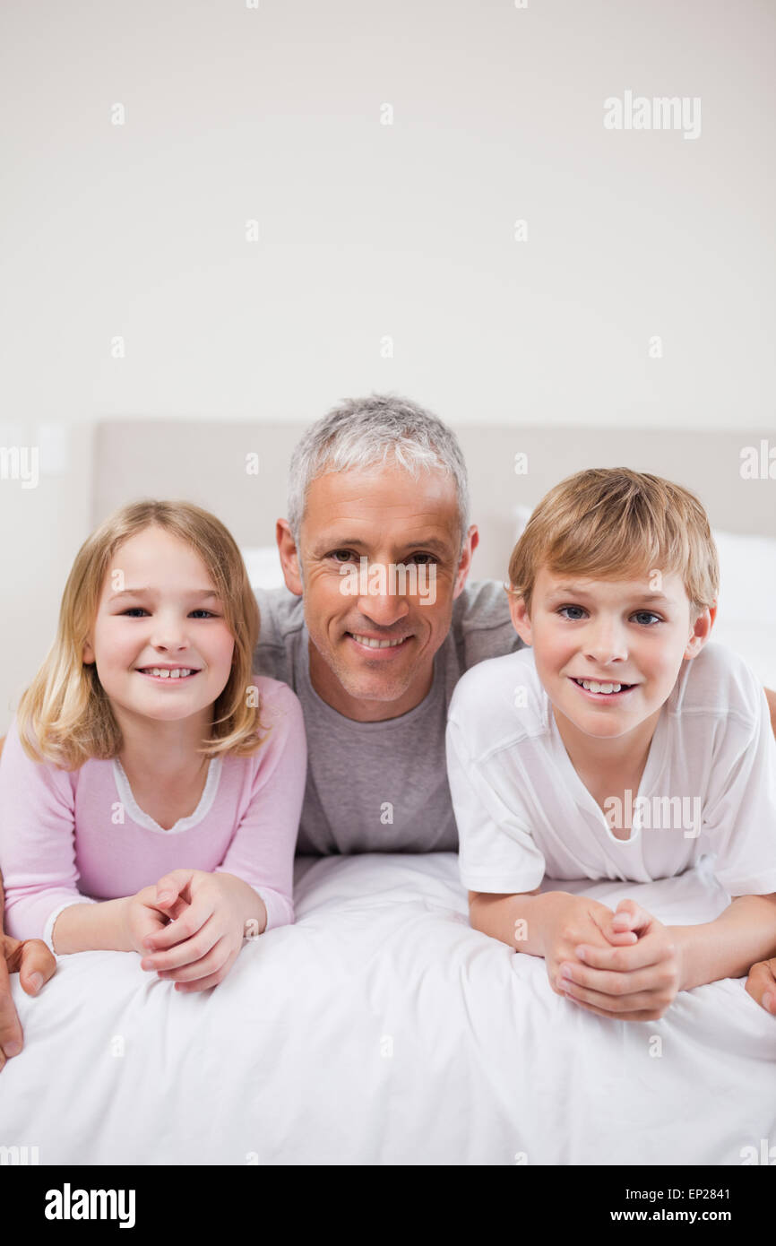 Portrait of siblings and their father posing Stock Photo - Alamy