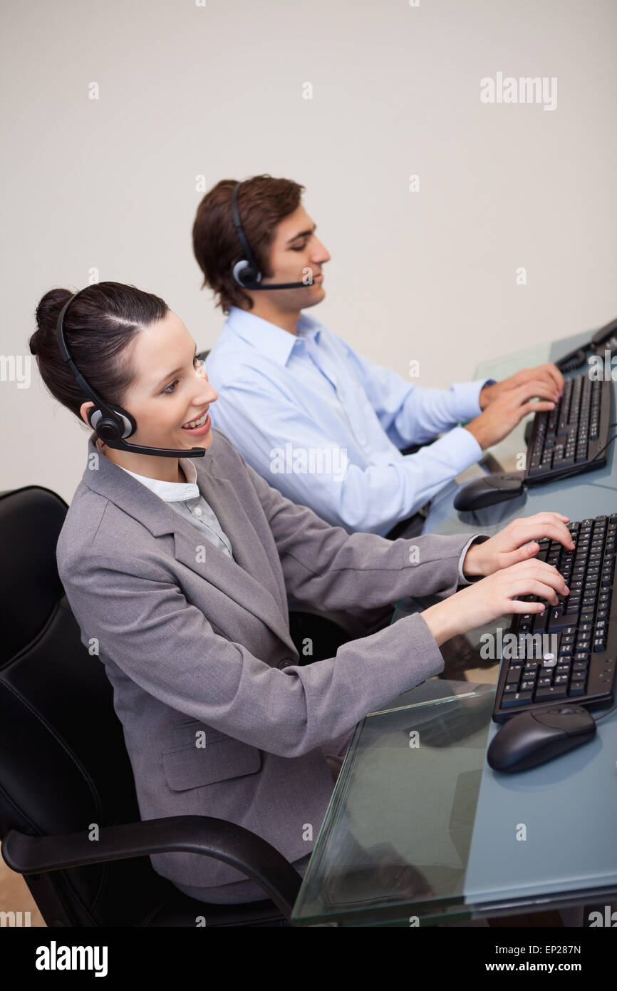 Side view of call center agents doing their work Stock Photo - Alamy