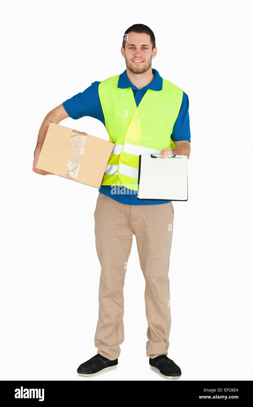 Smiling young delivery man asking for signature Stock Photo - Alamy