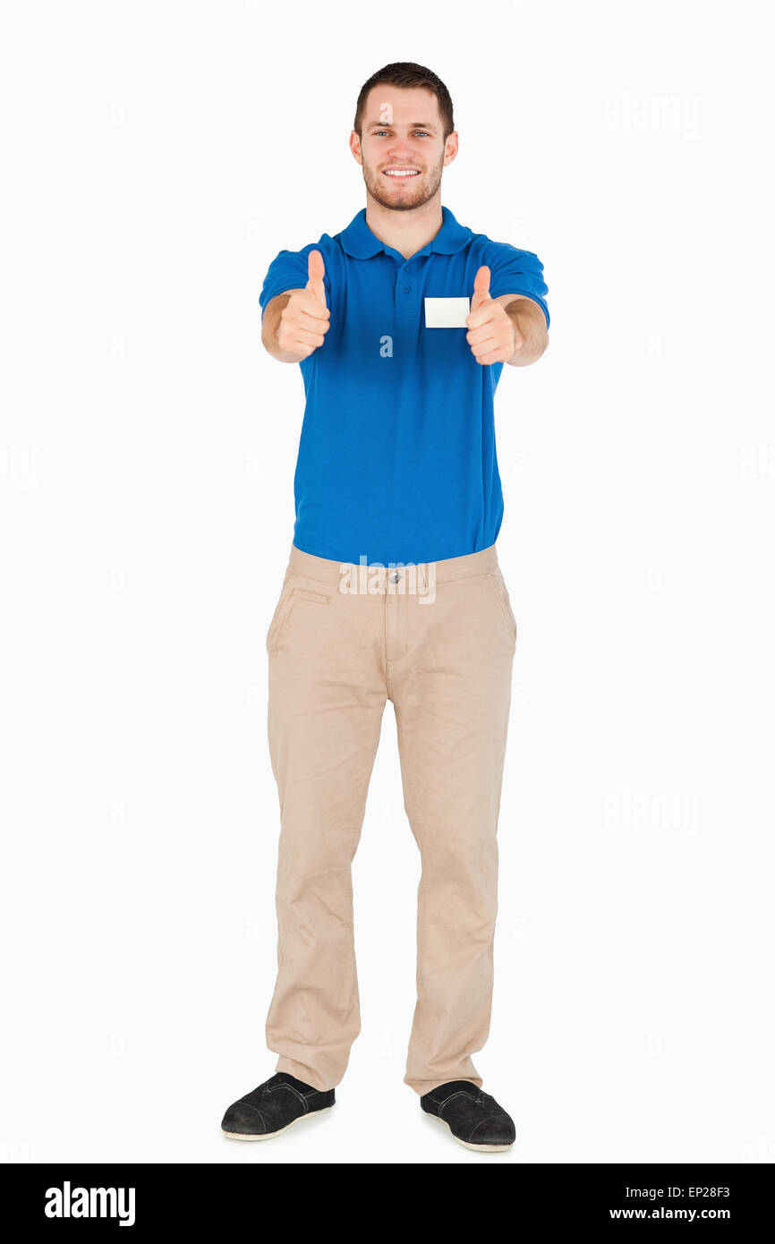 Smiling young sales assistant giving thumbs up Stock Photo - Alamy