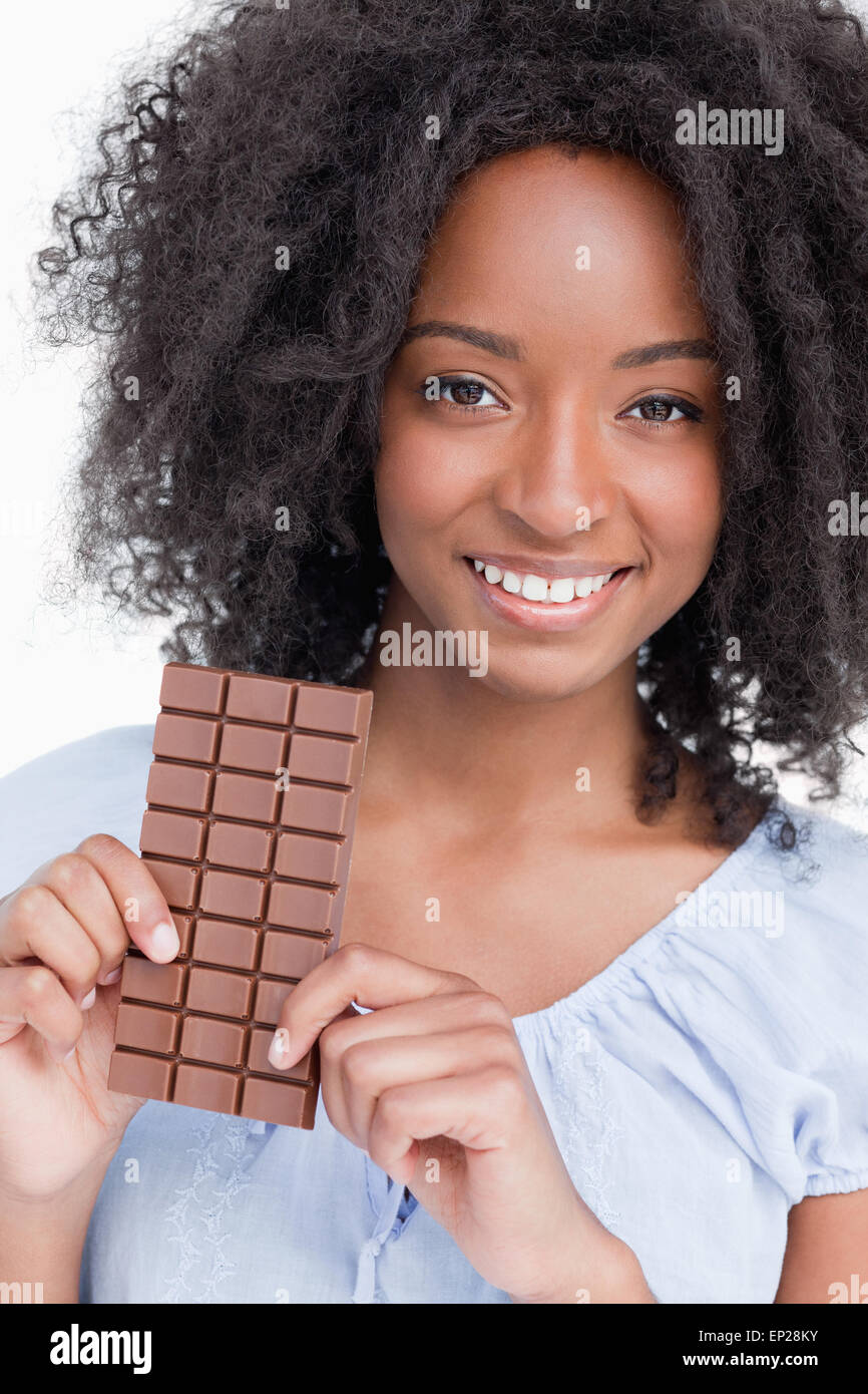 Young woman looking at a bar of chocolate hi-res stock photography and ...