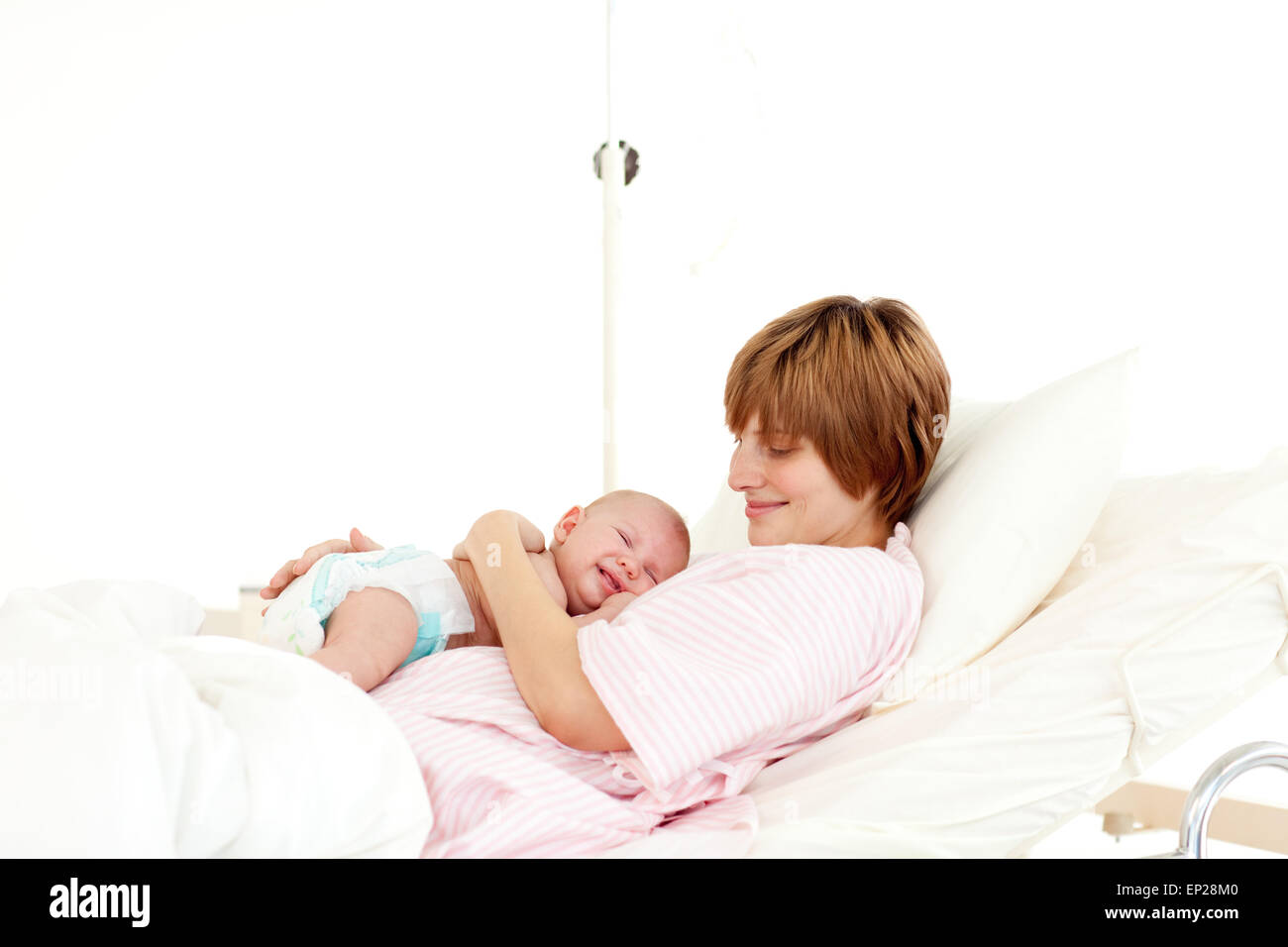 Happy patient with newborn baby in bed Stock Photo - Alamy