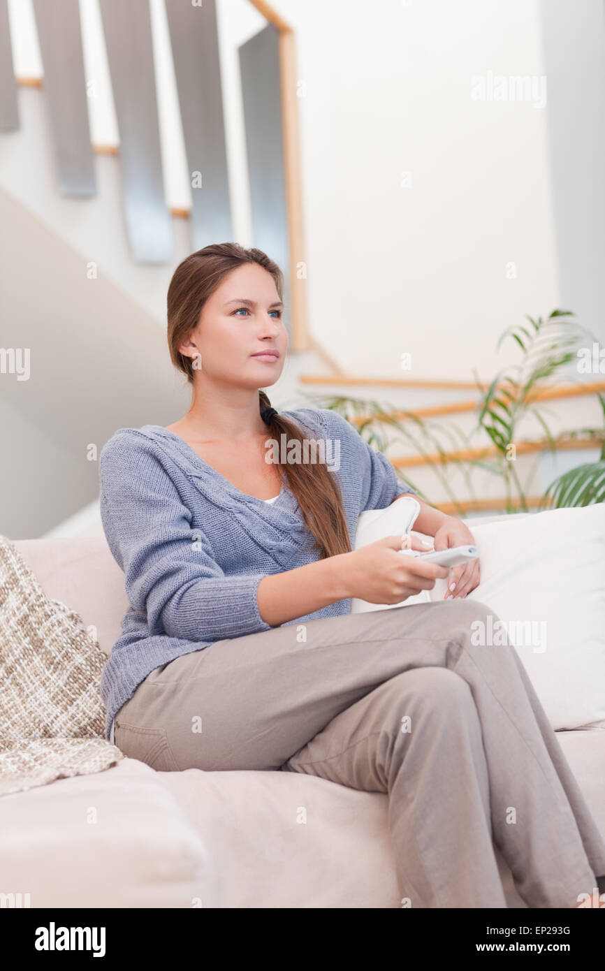 Portrait of a young woman watching TV Stock Photo - Alamy